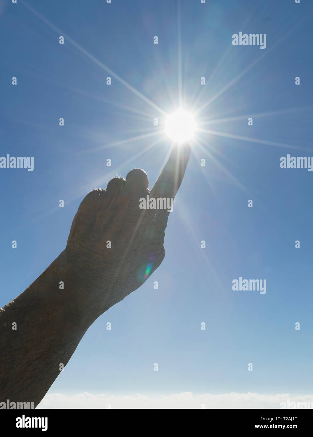 Hand pointing at sun Stock Photo - Alamy