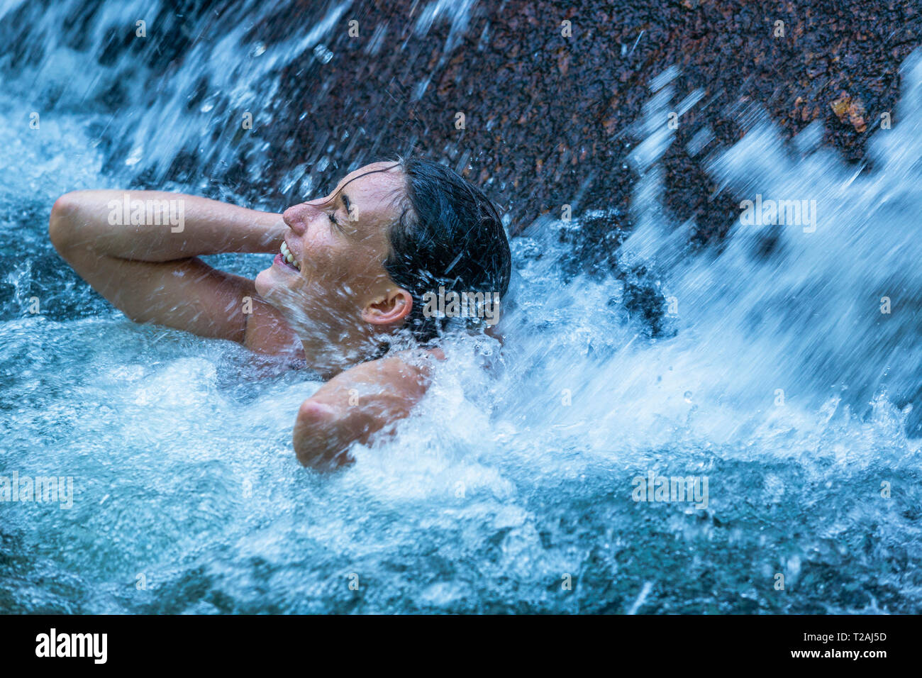 Woman under waterfall hi-res stock photography and images - Alamy