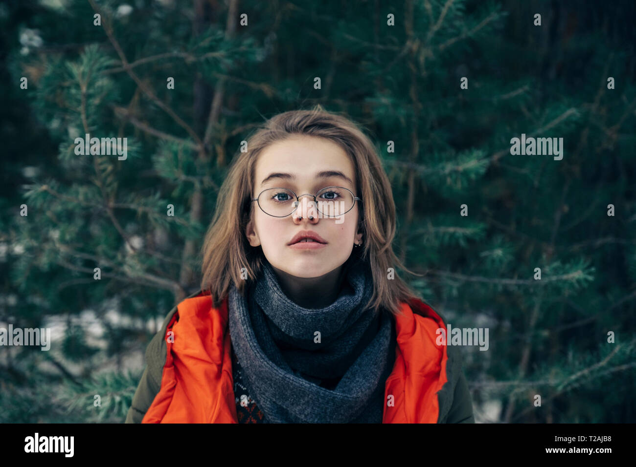 Teenage girl with glasses by pine tree Stock Photo - Alamy