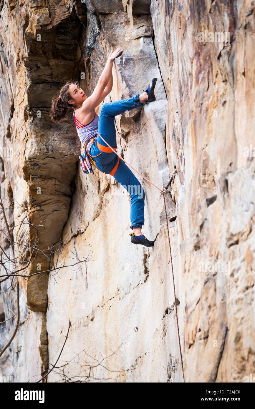Teenage girl rock climbing Stock Photo - Alamy