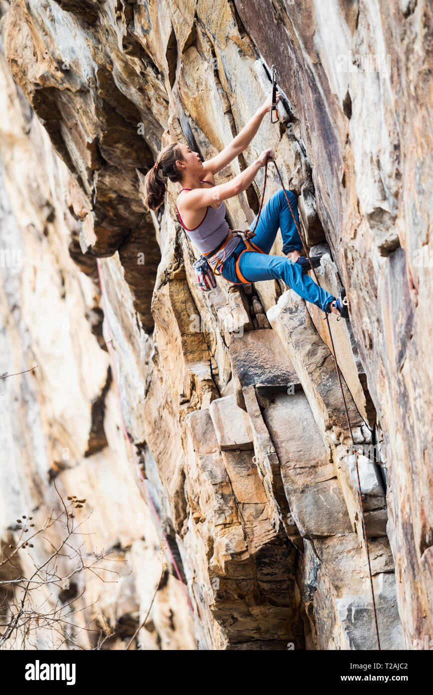 Teenage girl rock climbing Stock Photo - Alamy