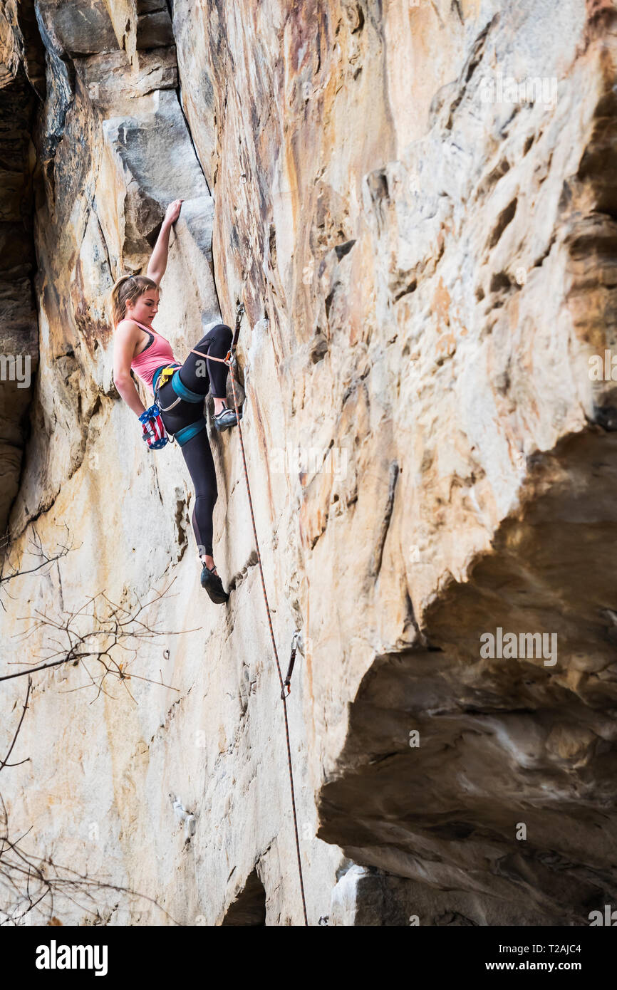 Teenage girl rock climbing Stock Photo - Alamy