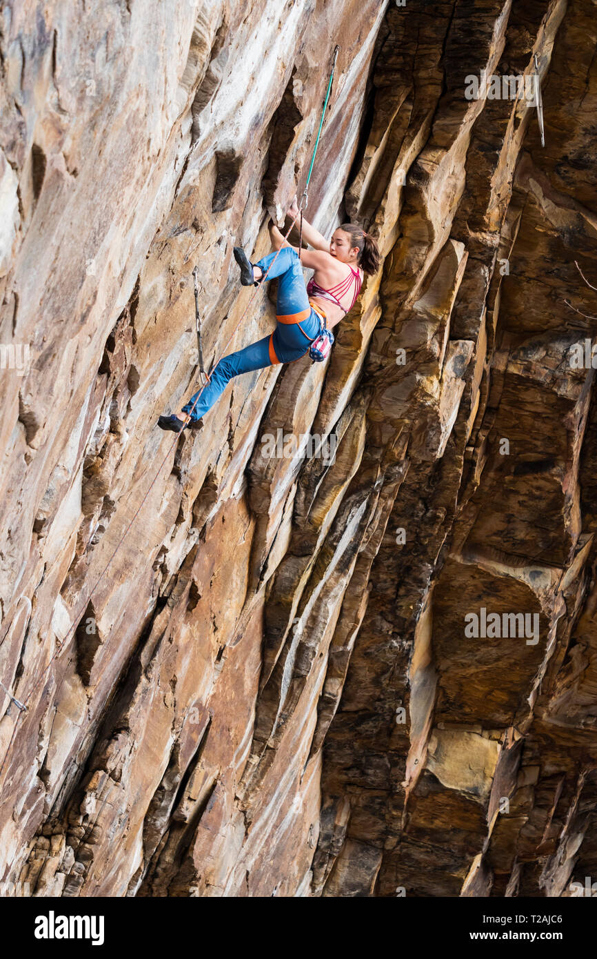 Teenage girl rock climbing Stock Photo - Alamy