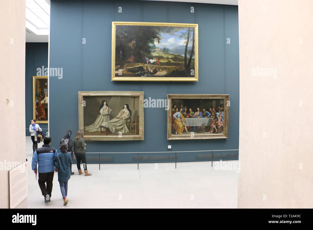 Blue wall at the Louvre museum with different paintings Stock Photo - Alamy