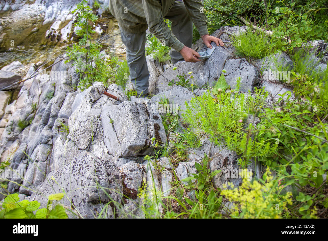 Man with geologic compass Stock Photo - Alamy