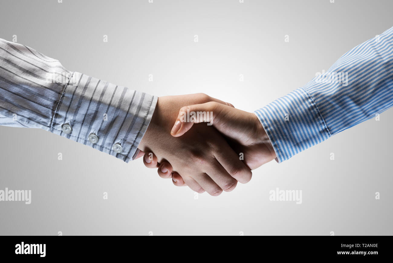 Business handshake as idea for unity and cooperation or greeting. Mixed ...