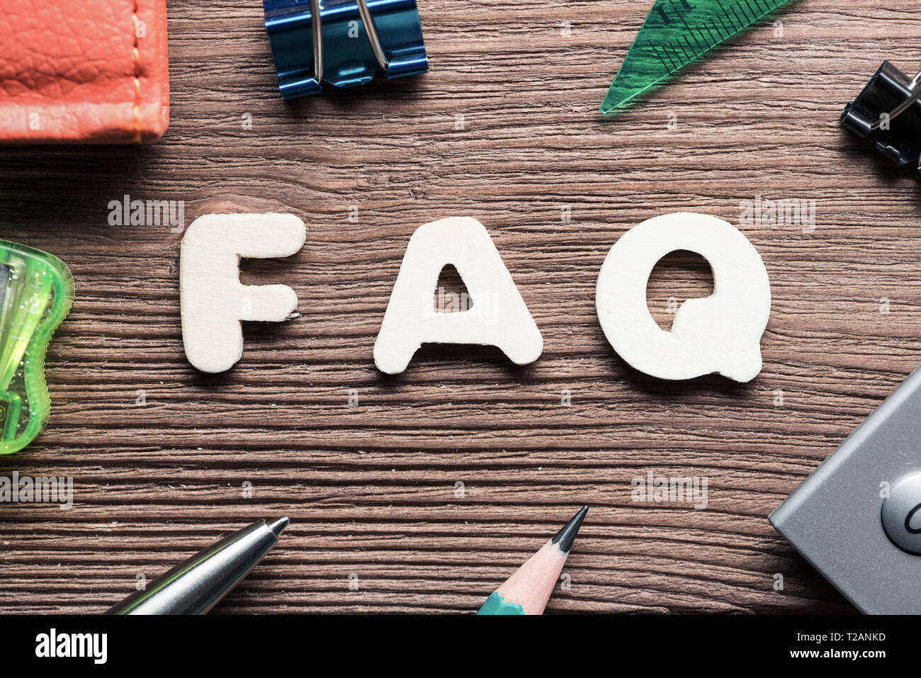 FAQ word on wooden table and office stationary around Stock Photo - Alamy