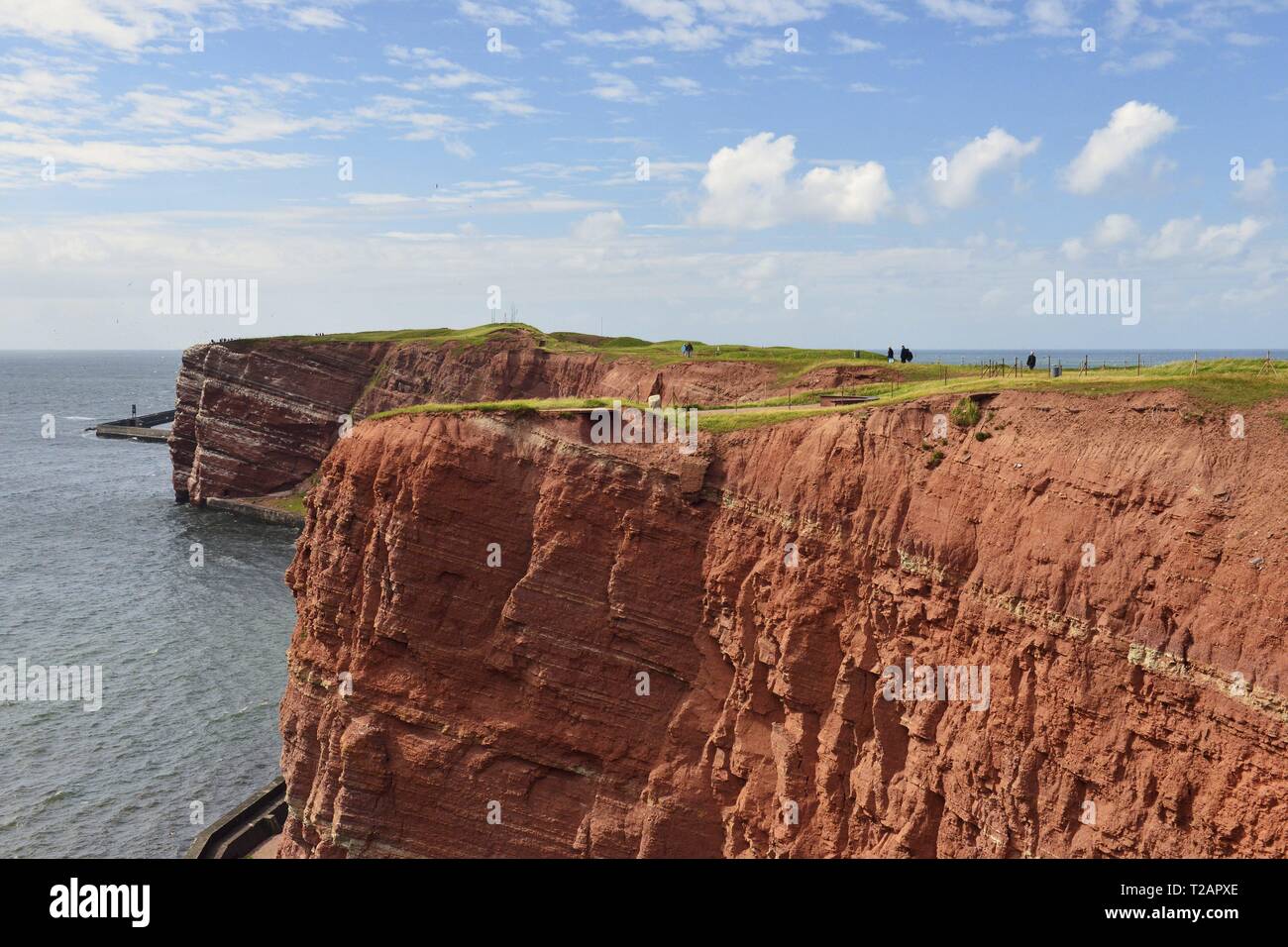 The red border of the mottled sandstone cliff from the island ...