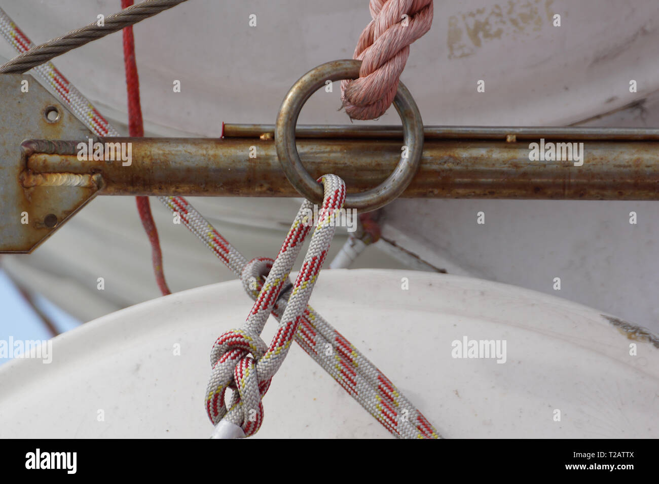 Steel rope and rusty hook on the back side of the sailing boat. Flag of ...