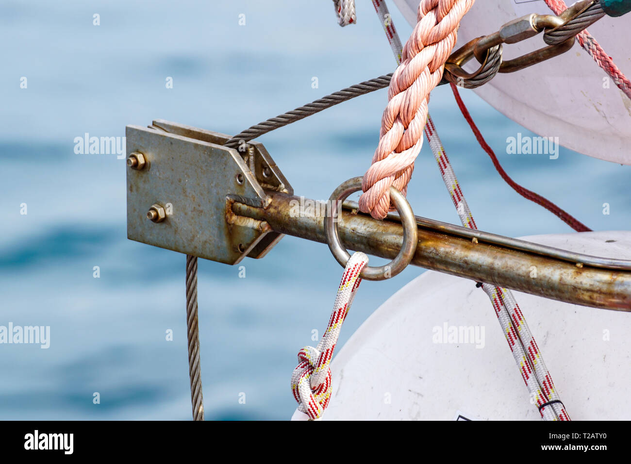 Steel rope and rusty hook on the back side of the sailing boat. Flag of ...