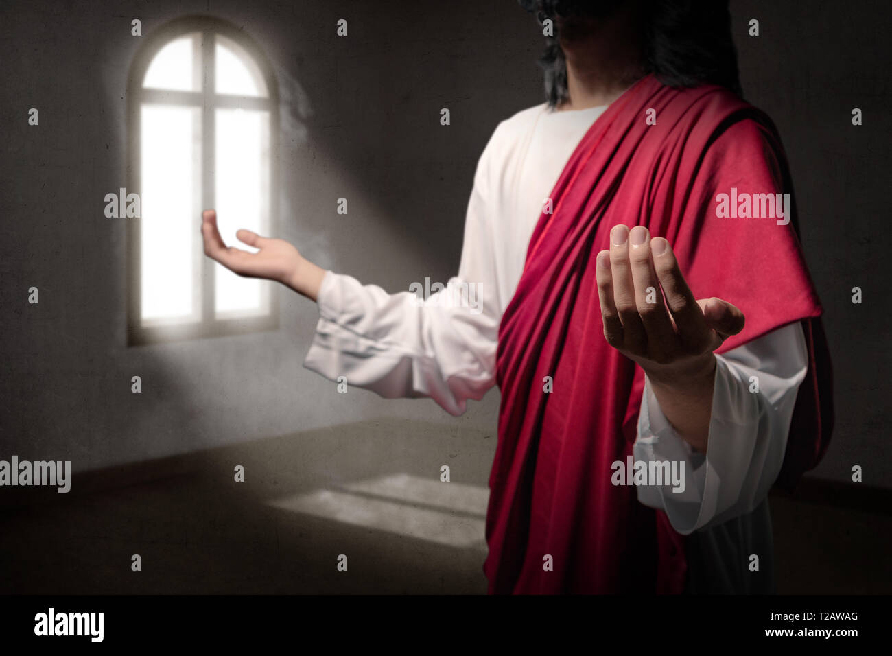 Jesus christ raised hands with open palms and praying to god inside the ...