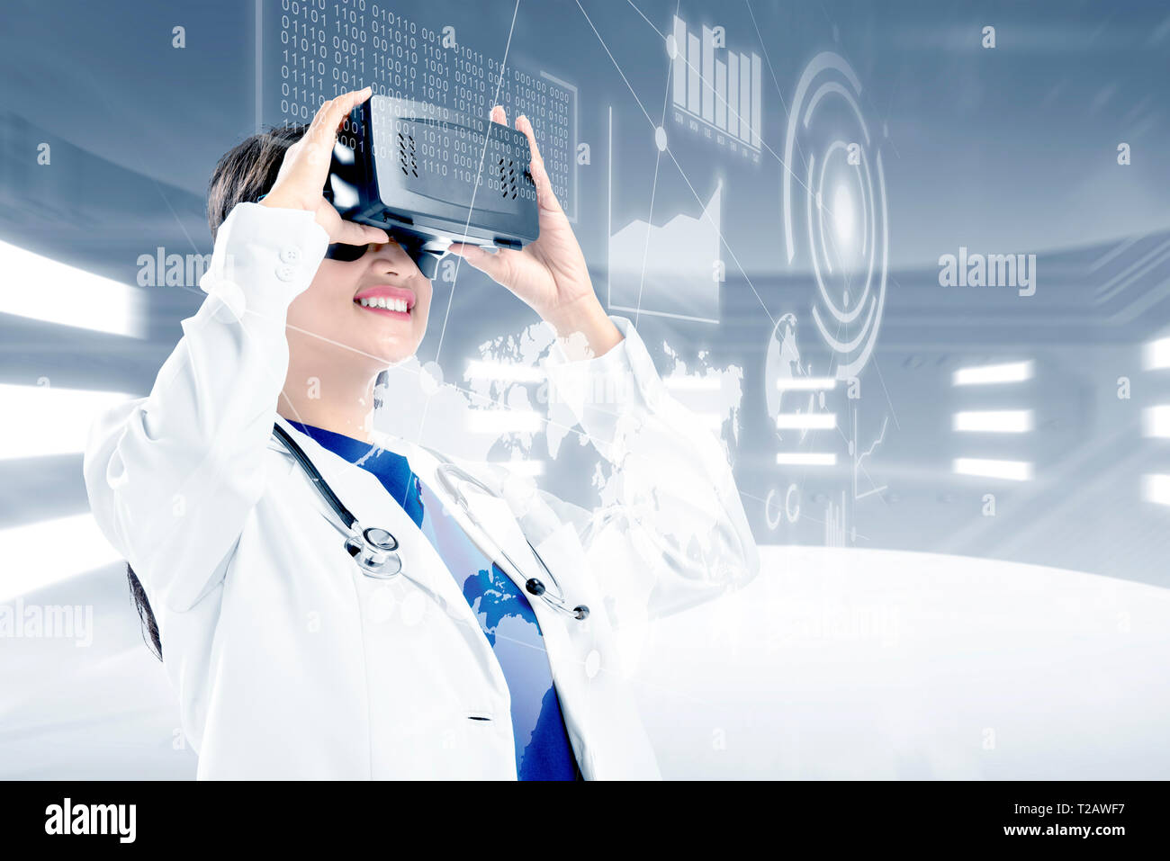 Asian female doctor in white coat and stethoscope looking at digital ...