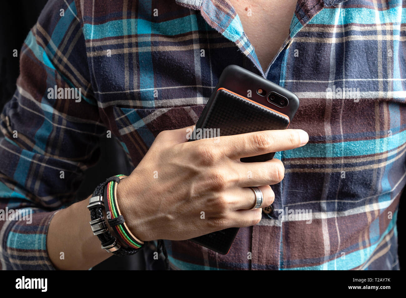 Person holding a portable charger with a smartphone in his hand Stock ...