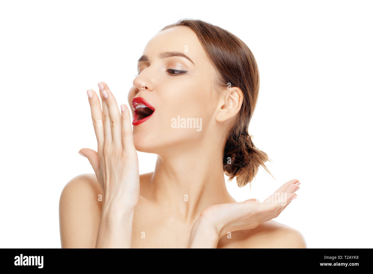 Pretty girl with healthy fresh skin turned her head and cover her mouth ...