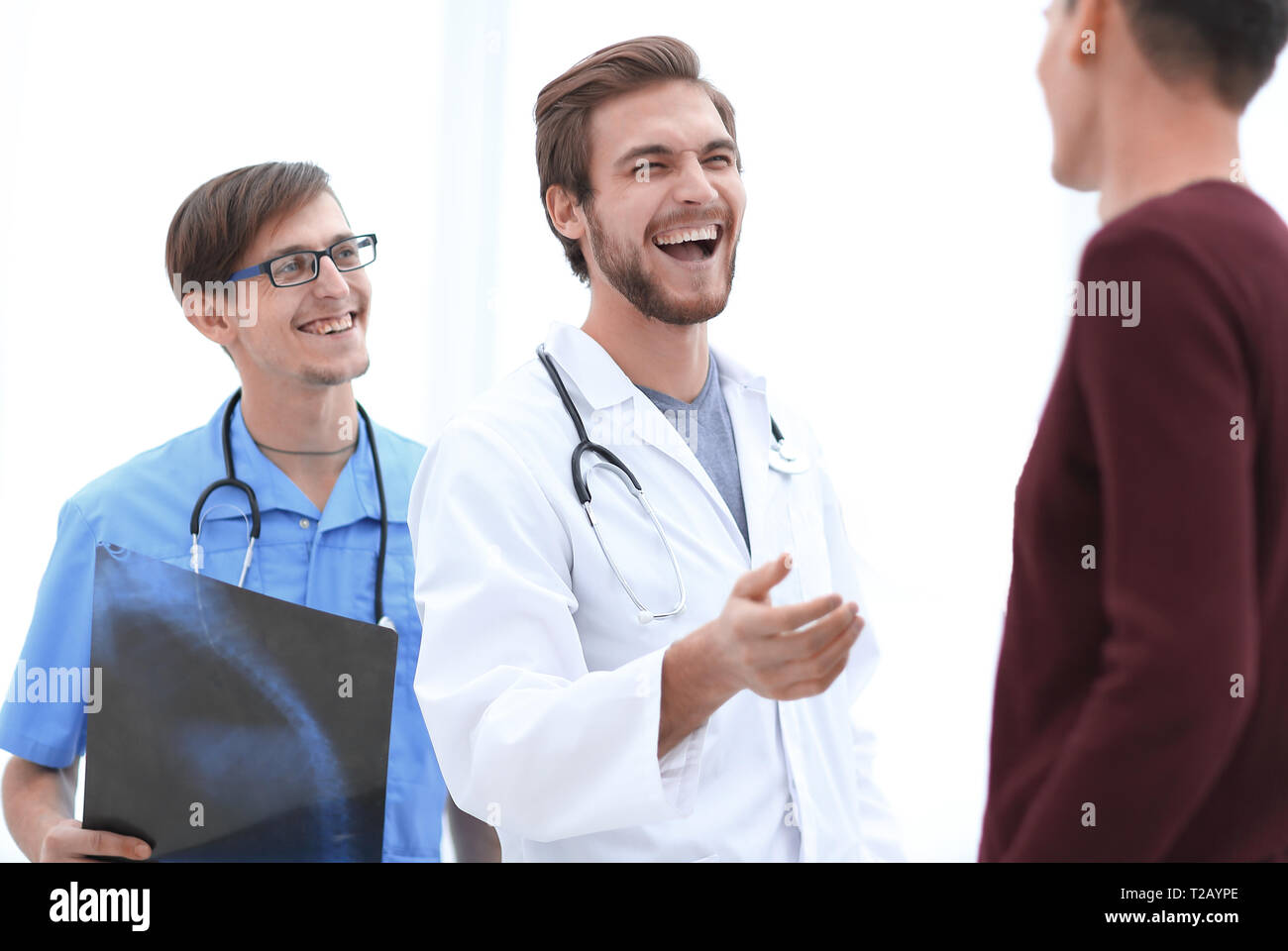 happy doctors with x-ray of the patient Stock Photo - Alamy