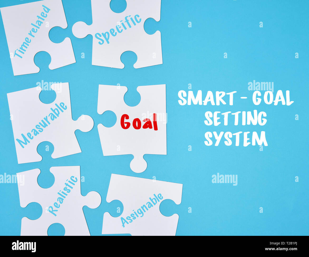 white big paper puzzles on a blue background, concept of smart goal ...