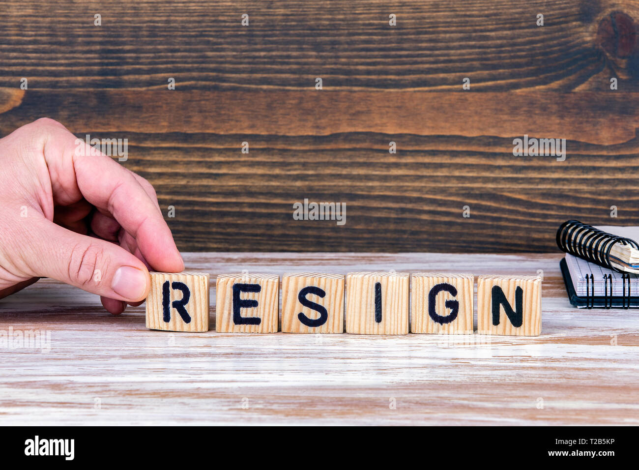 Resign. Wooden letters on the office desk, informative and ...