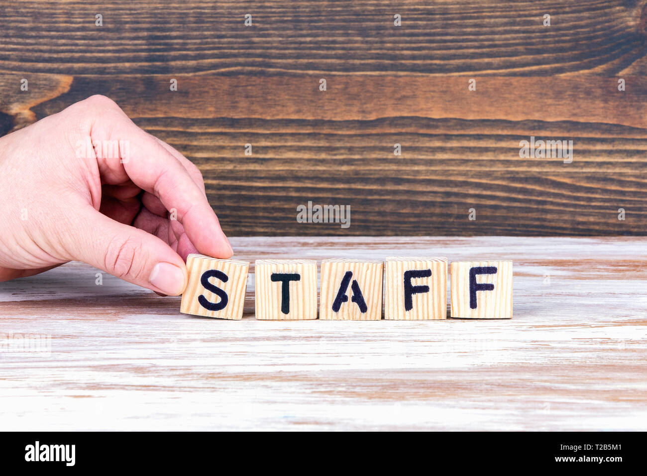 Staff. Wooden letters on the office desk, informative and communication ...