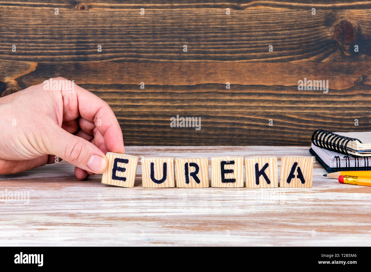 Eureka. Wooden letters on the office desk, informative and ...