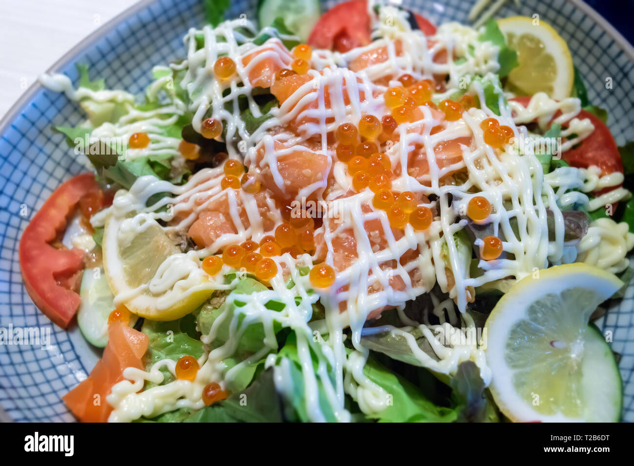 Vegetable salad salmon and salmond roe with indoor low lighting Stock ...