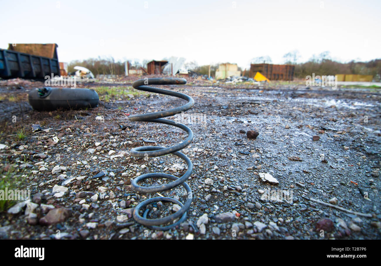 A large metal spring sits on the ground at the abandoned Furber's ...