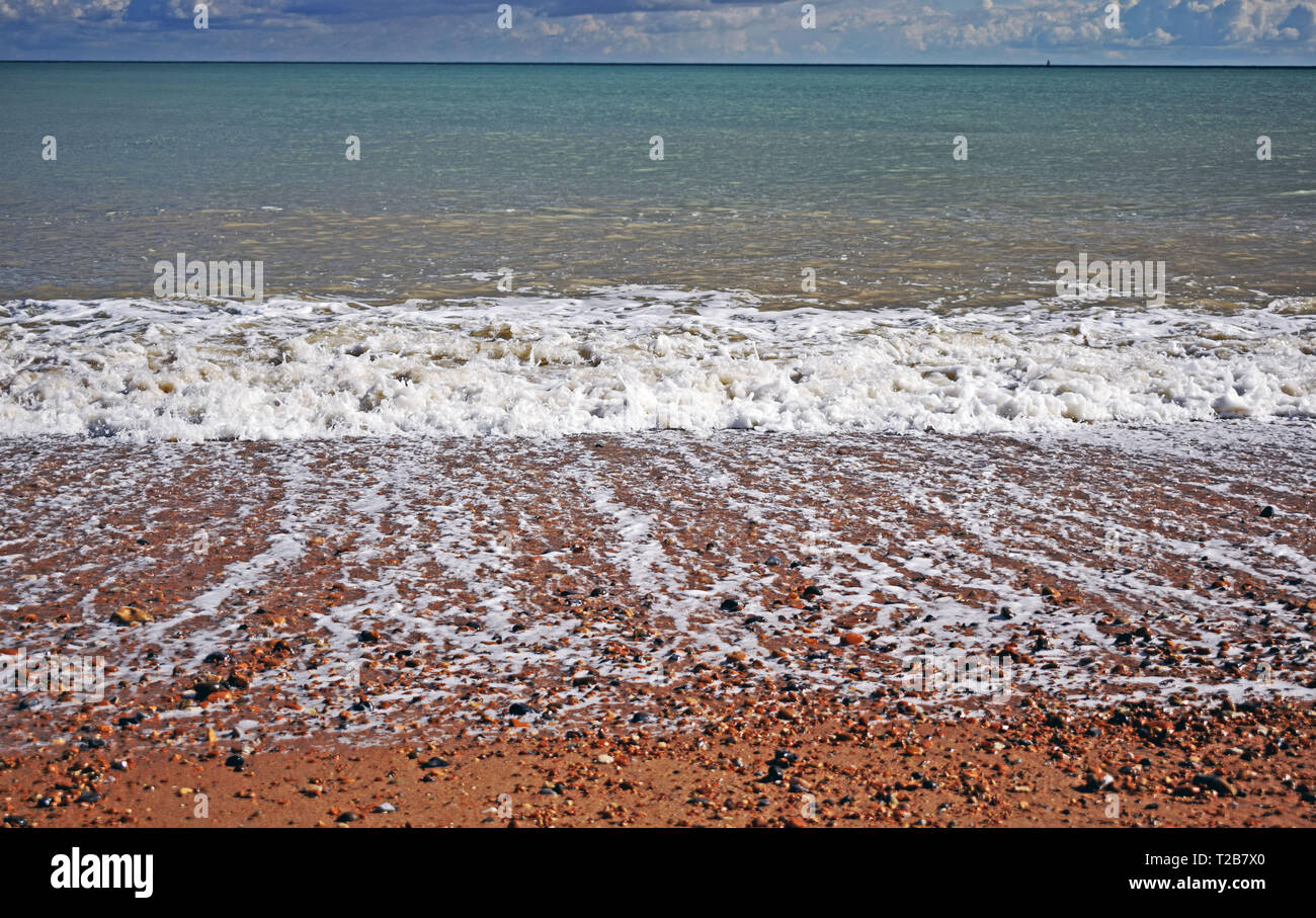 Sea waves creating white sea spray ,foam and bubbles as it rolls onto ...