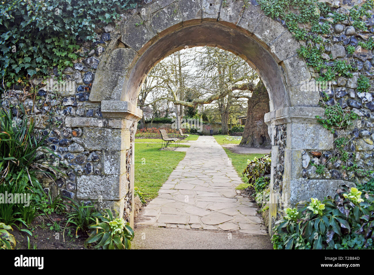 A archway is a stone wall leading to a garden Stock Photo - Alamy