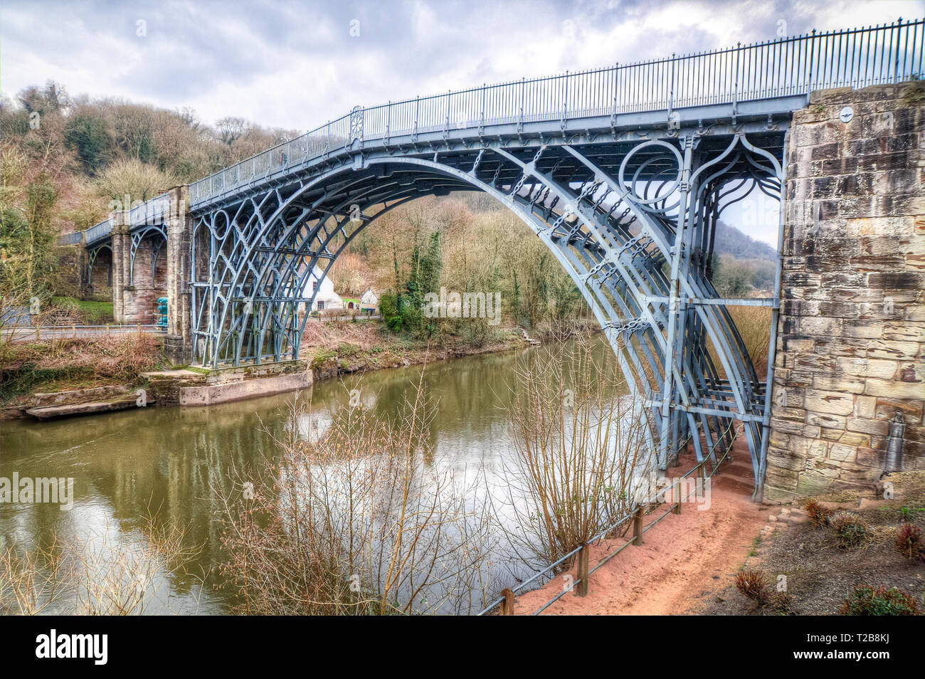 The famous and ancient Iron Bridge rises over the River Severn in ...