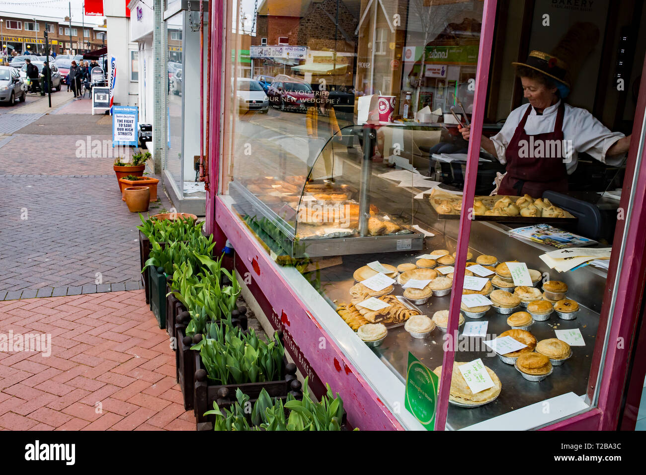 Hunstanton, England. 23 March 2019. The lady in bakery checking on the ...