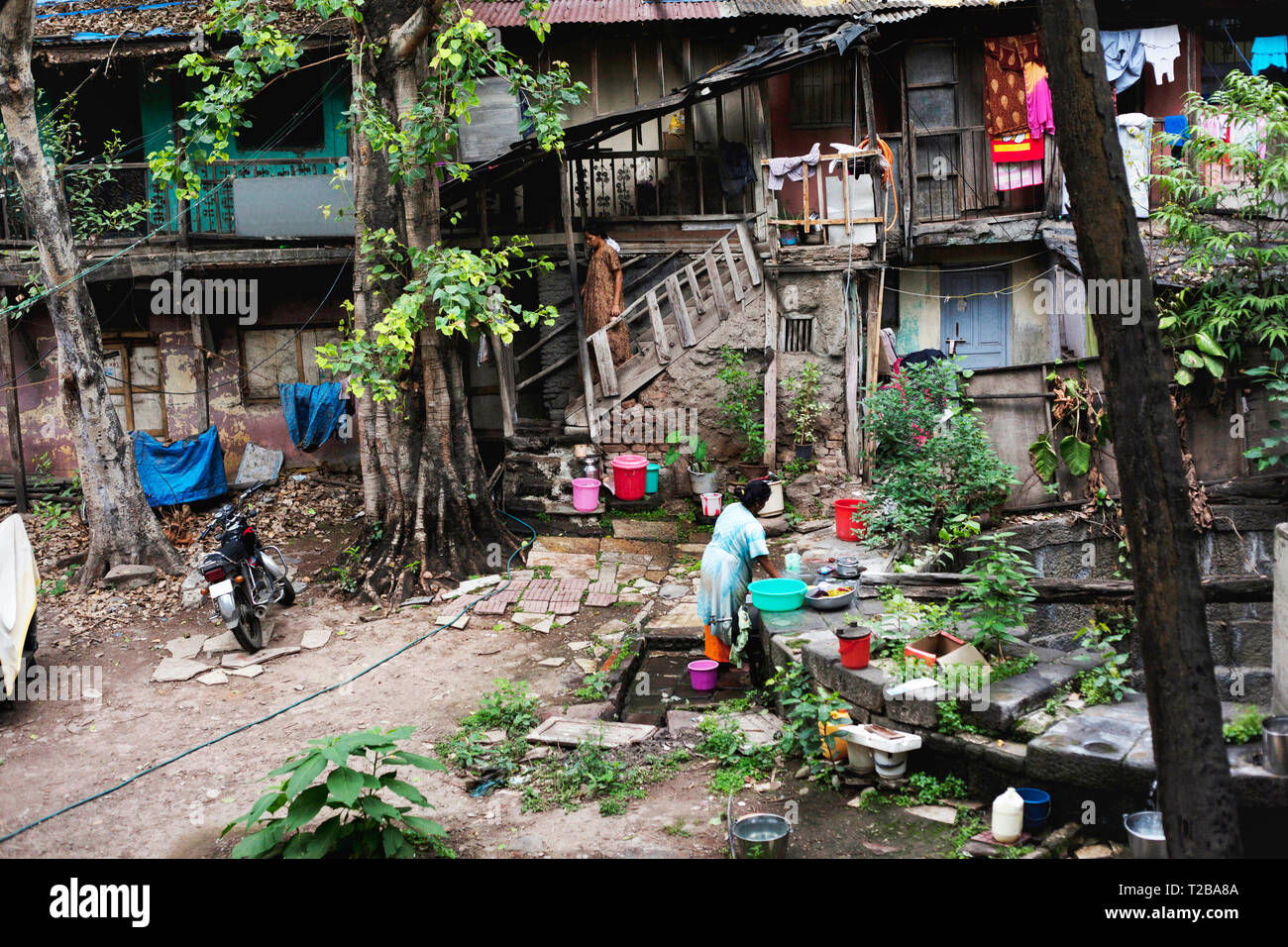 Woman washing utensils at old building in Wadas of Pune, India Stock ...