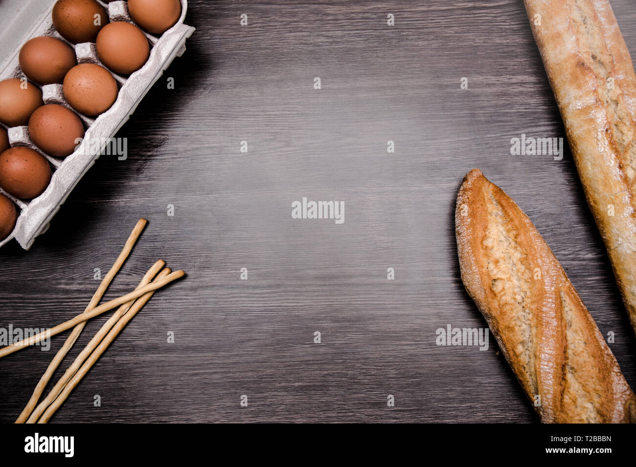 Flat lay top view of loaves of bread, sticks of bread an dozen of eggs ...