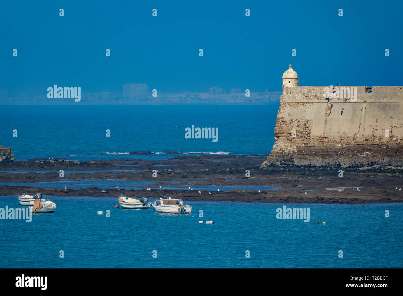 Cadiz fort near ocean in a misty day with blurred city Stock Photo - Alamy