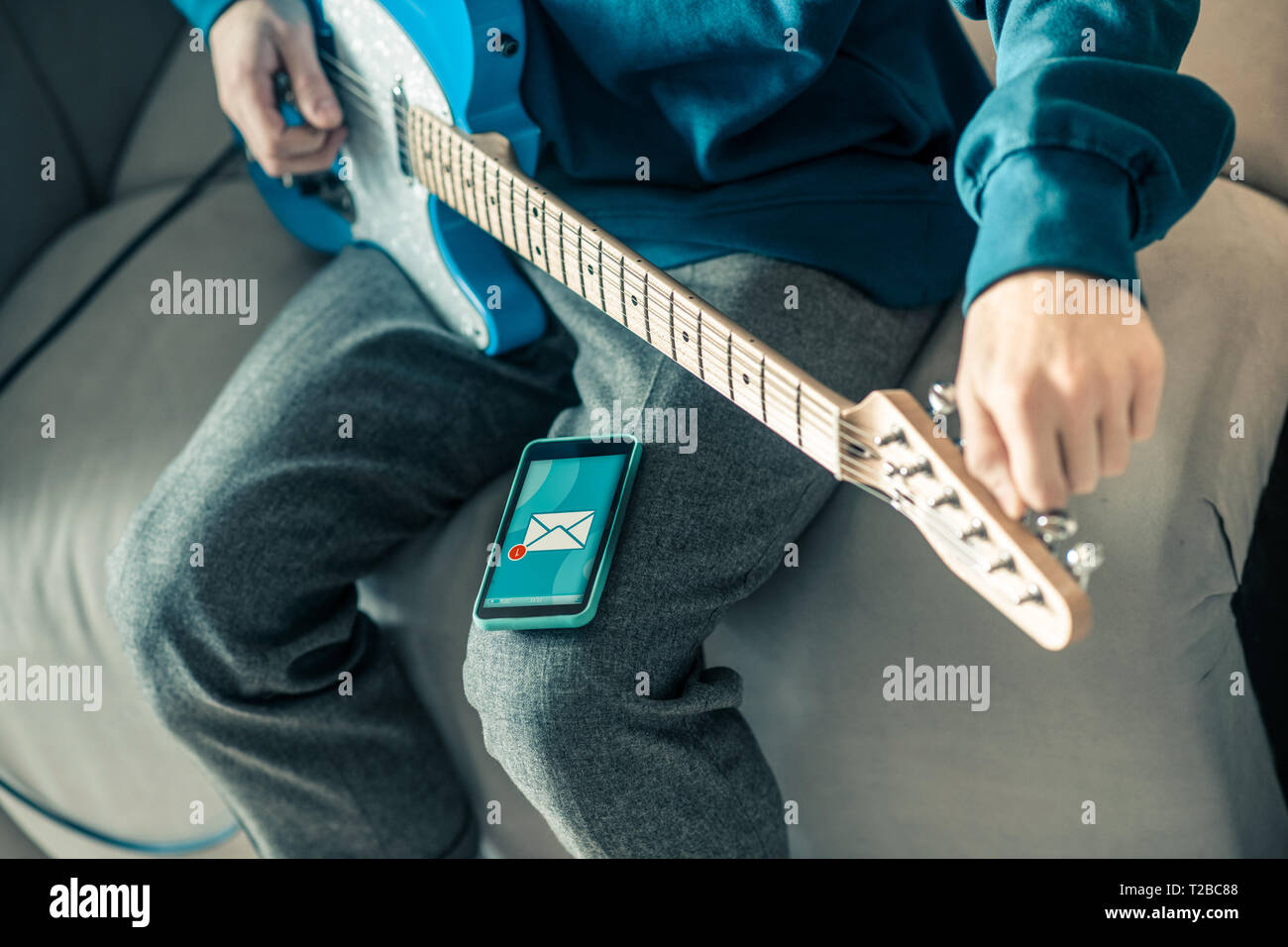 Hard-working musician tuning his musical instrument and observing ...