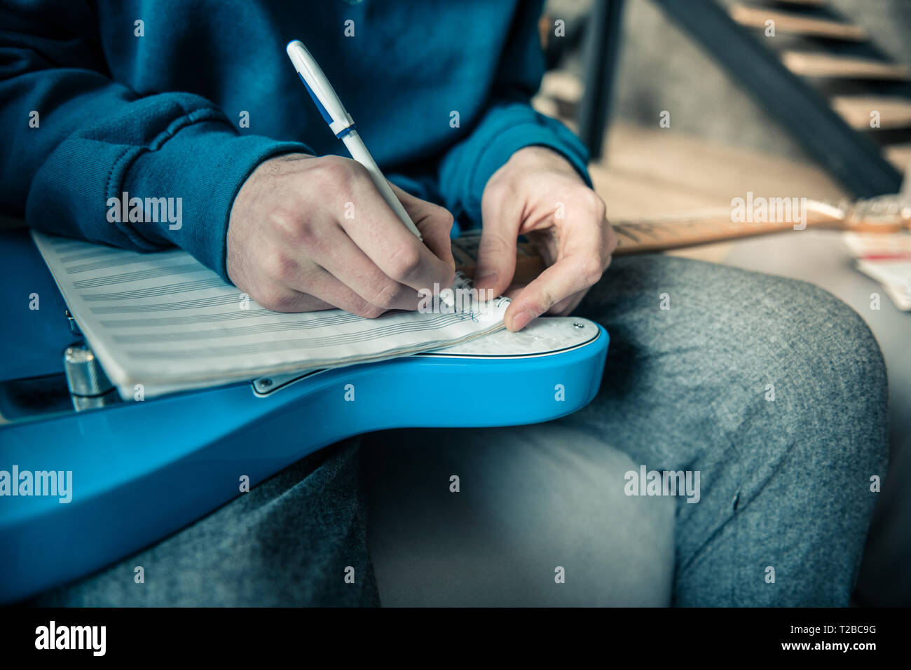 Professional young musician writing composition in special album Stock ...