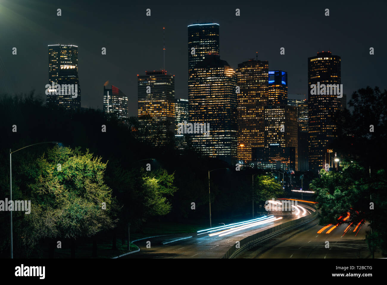 Memorial Drive and the Houston skyline at night, in Houston, Texas ...