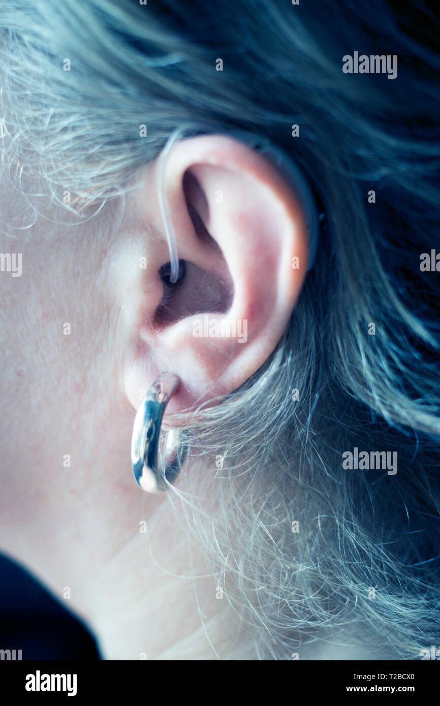 Deaf lady with modern technology digital hearing aid in her ear Stock ...
