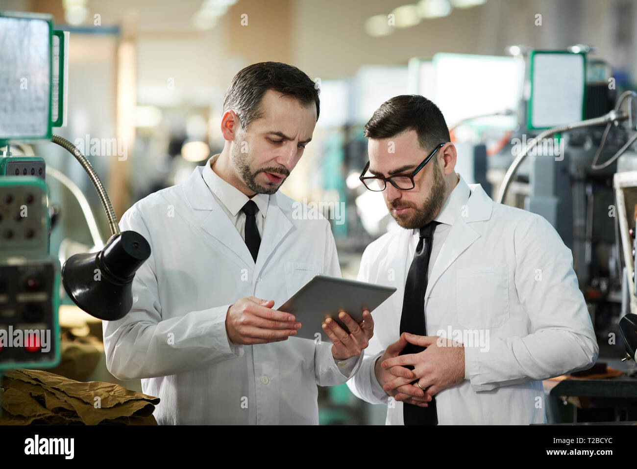 Two Workers at Modern Production Factory Stock Photo - Alamy