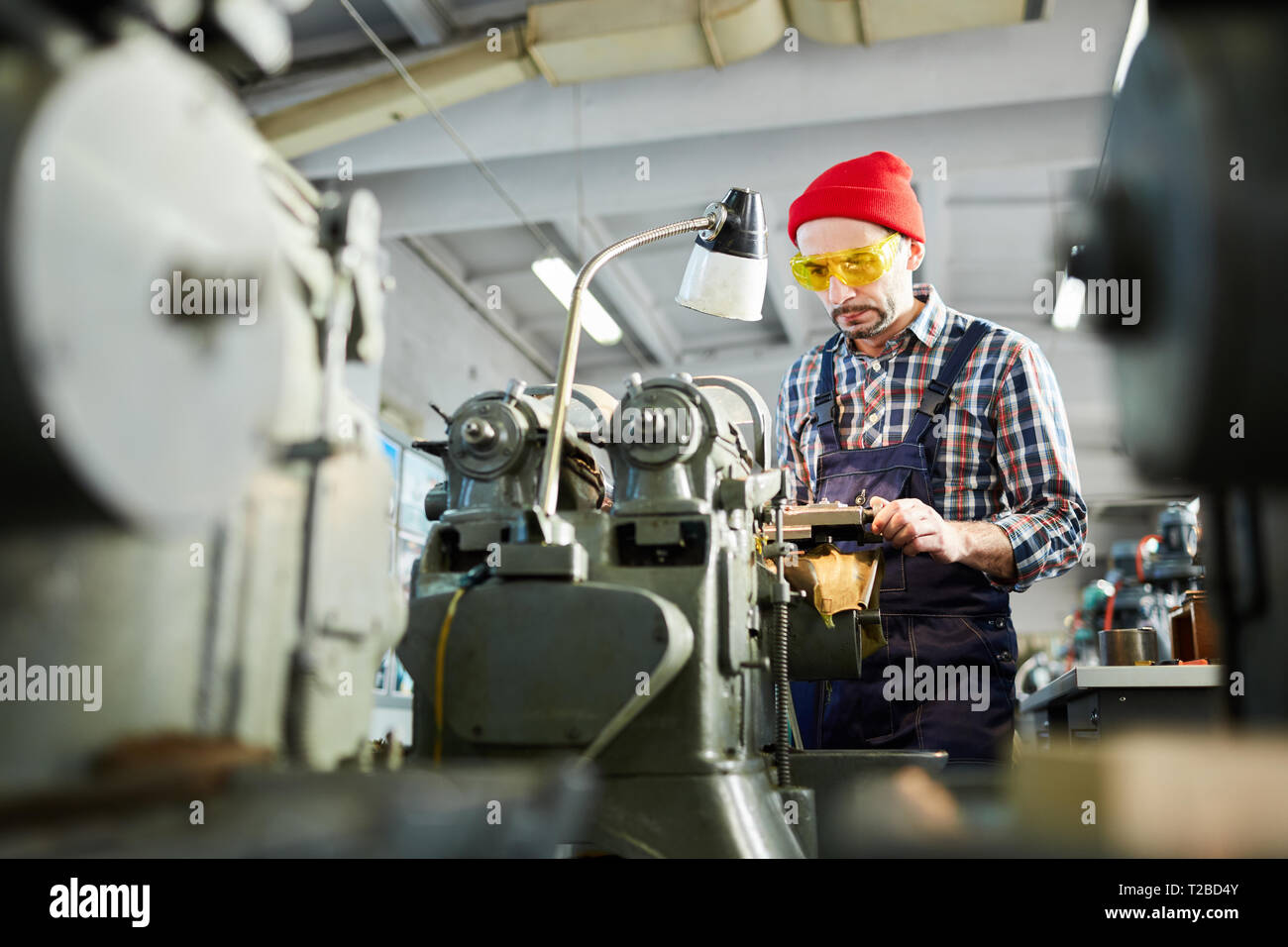 Factory Worker using Machine Unit Stock Photo - Alamy