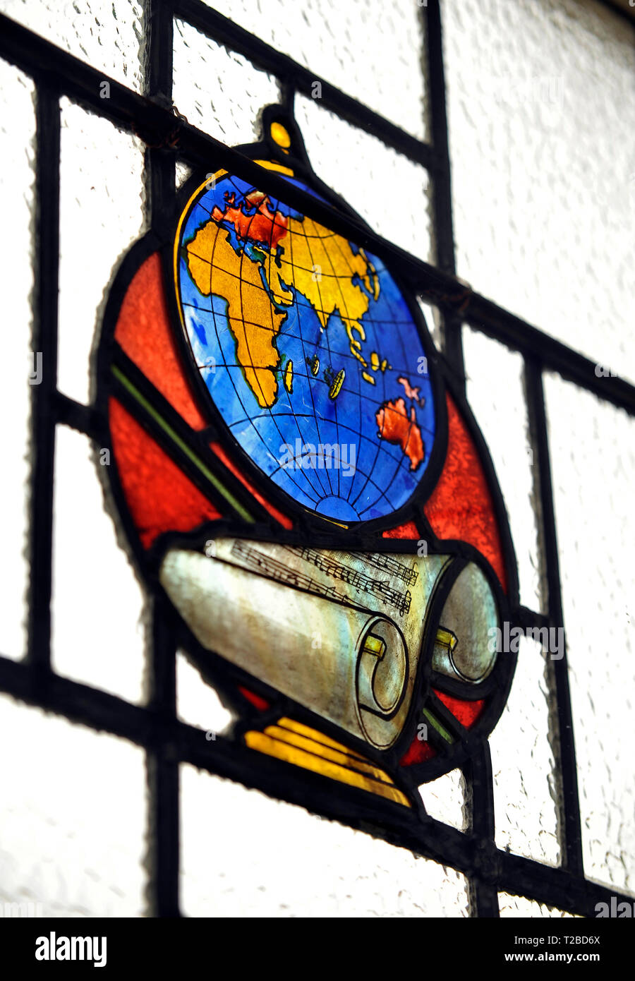 Stained glass window showing map of the World and a manuscript ...