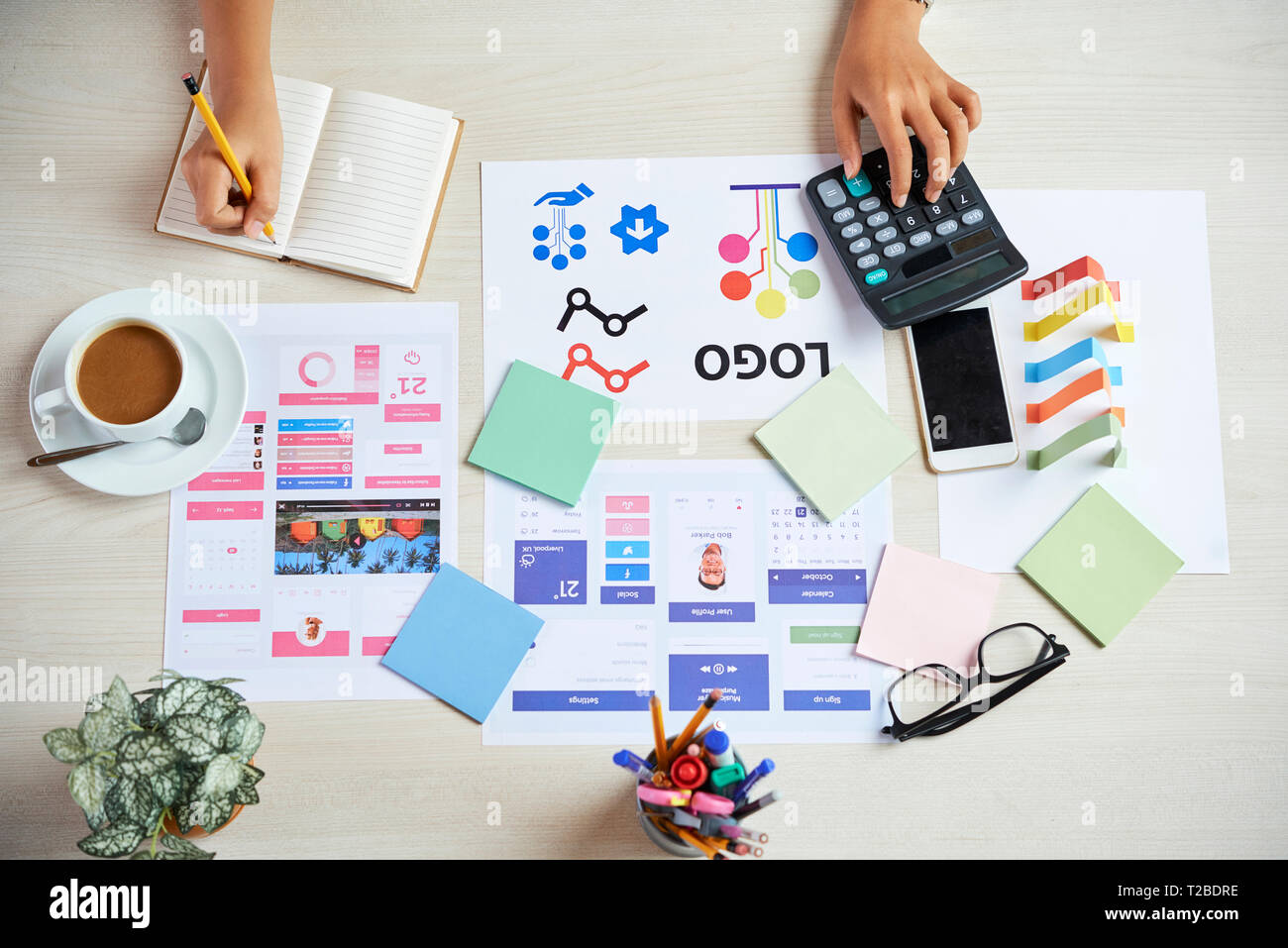 Designer calculating cost of work Stock Photo - Alamy