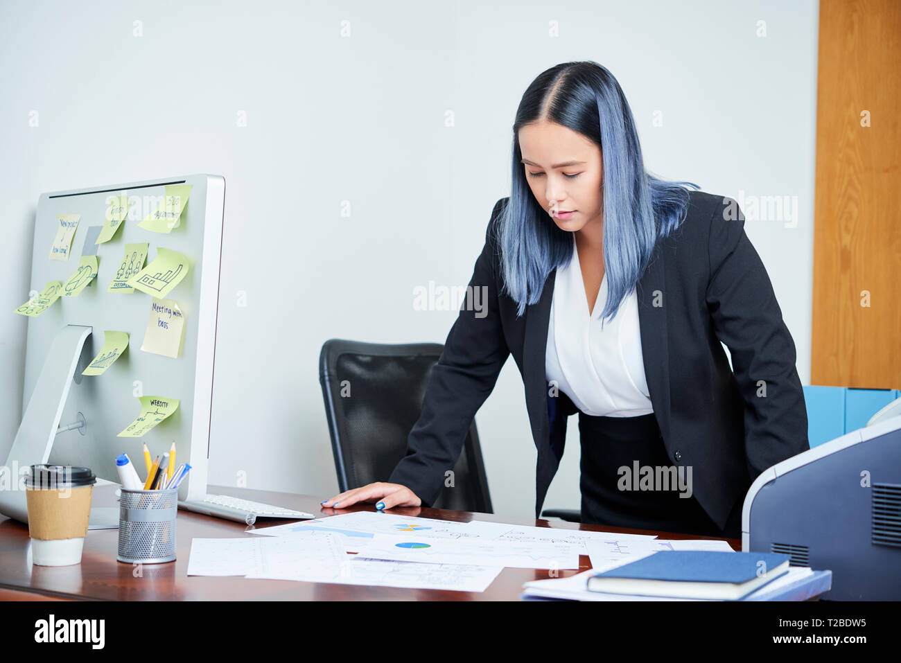 Female executive looking documents hi-res stock photography and images ...