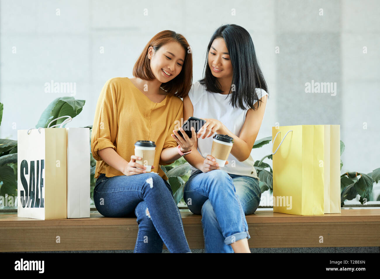 Friends checking social media Stock Photo - Alamy