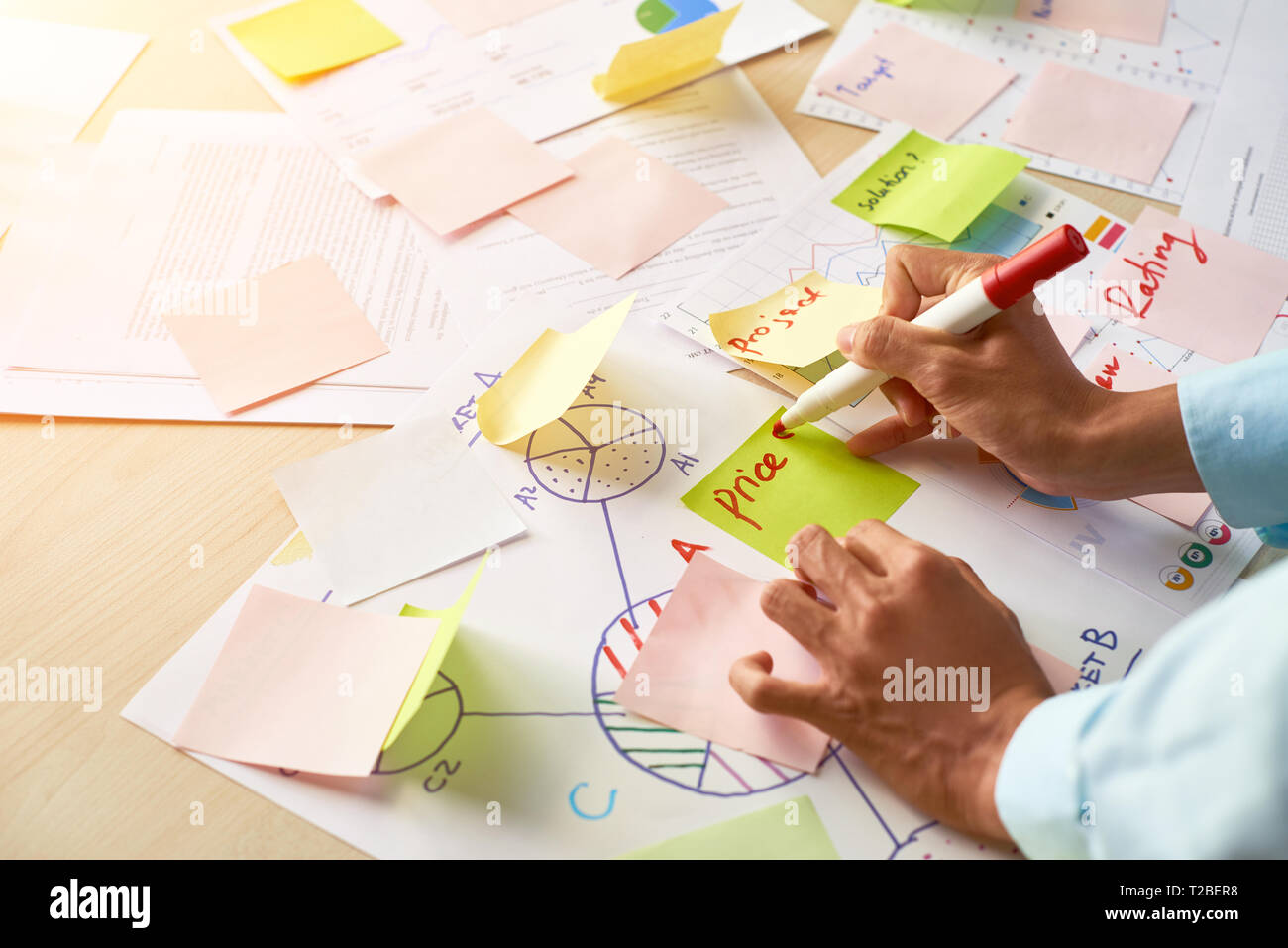 Businessman sticking notes on documents Stock Photo - Alamy