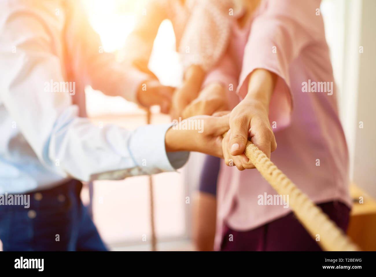 Coworkers pulling rope together Stock Photo - Alamy