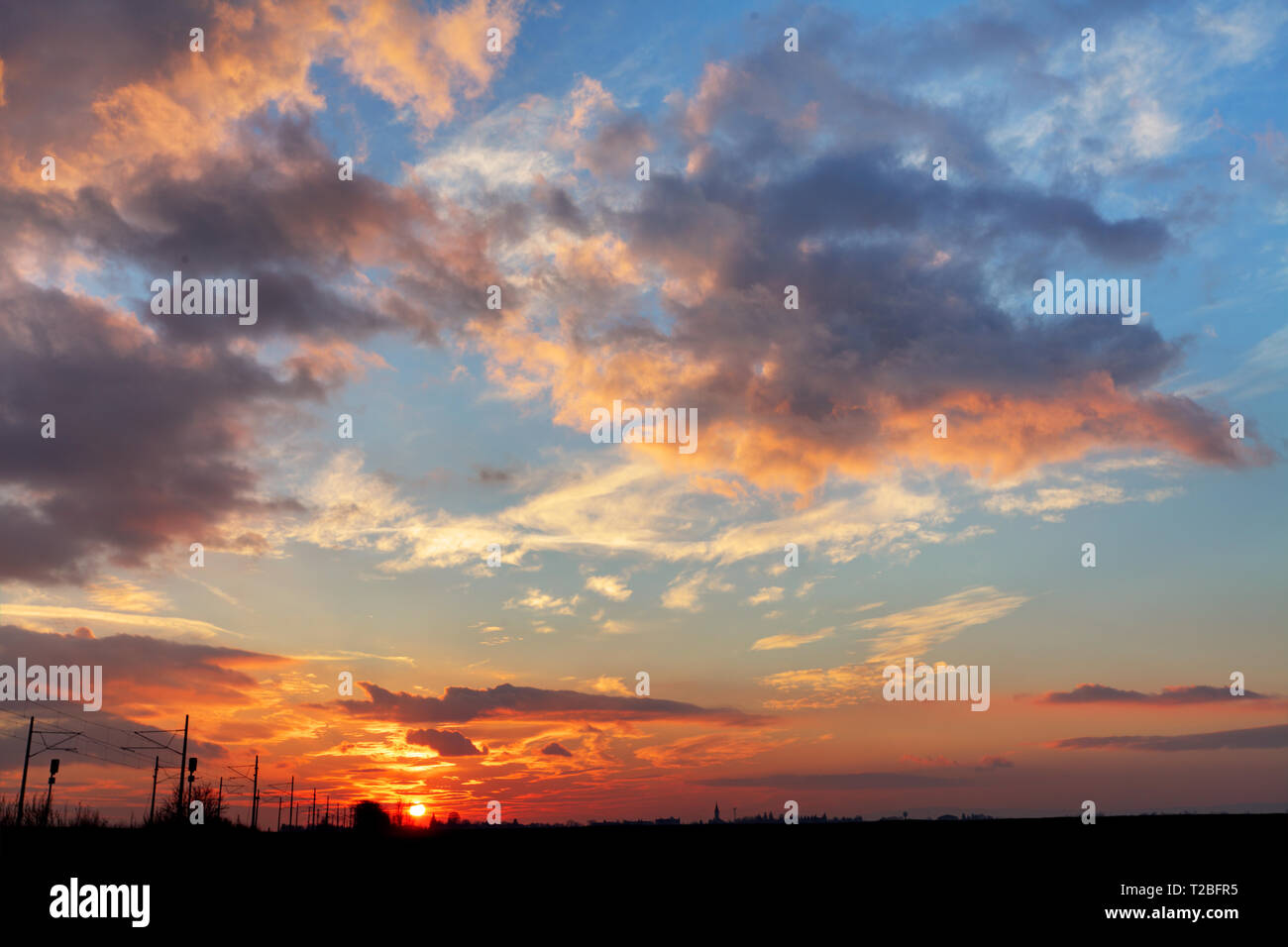 Sunset sky with dramatic clouds and red sun Stock Photo - Alamy