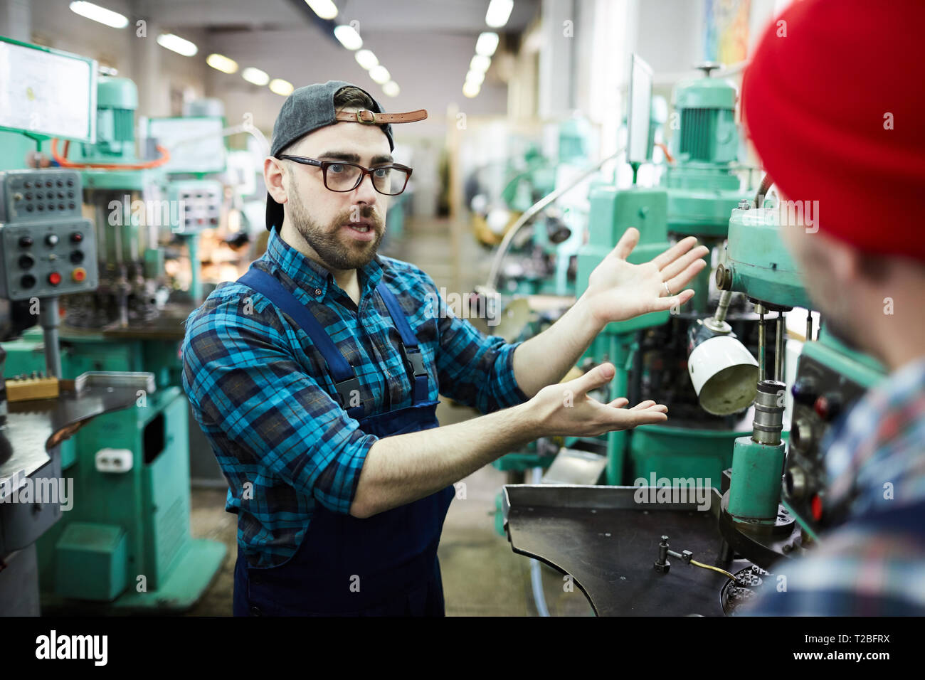 Two Workers Standing by Machine Units Stock Photo - Alamy