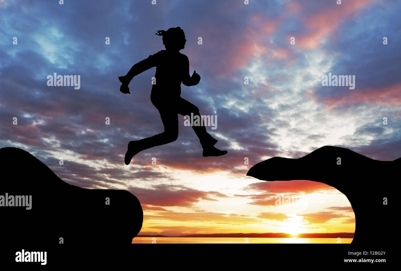 Silhouette man jumping over cliff hi-res stock photography and images ...