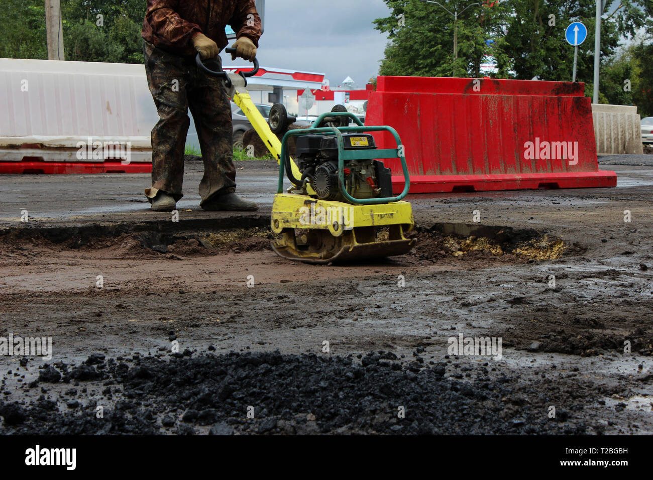 The foreman of the construction team works with a vibrating platform ...