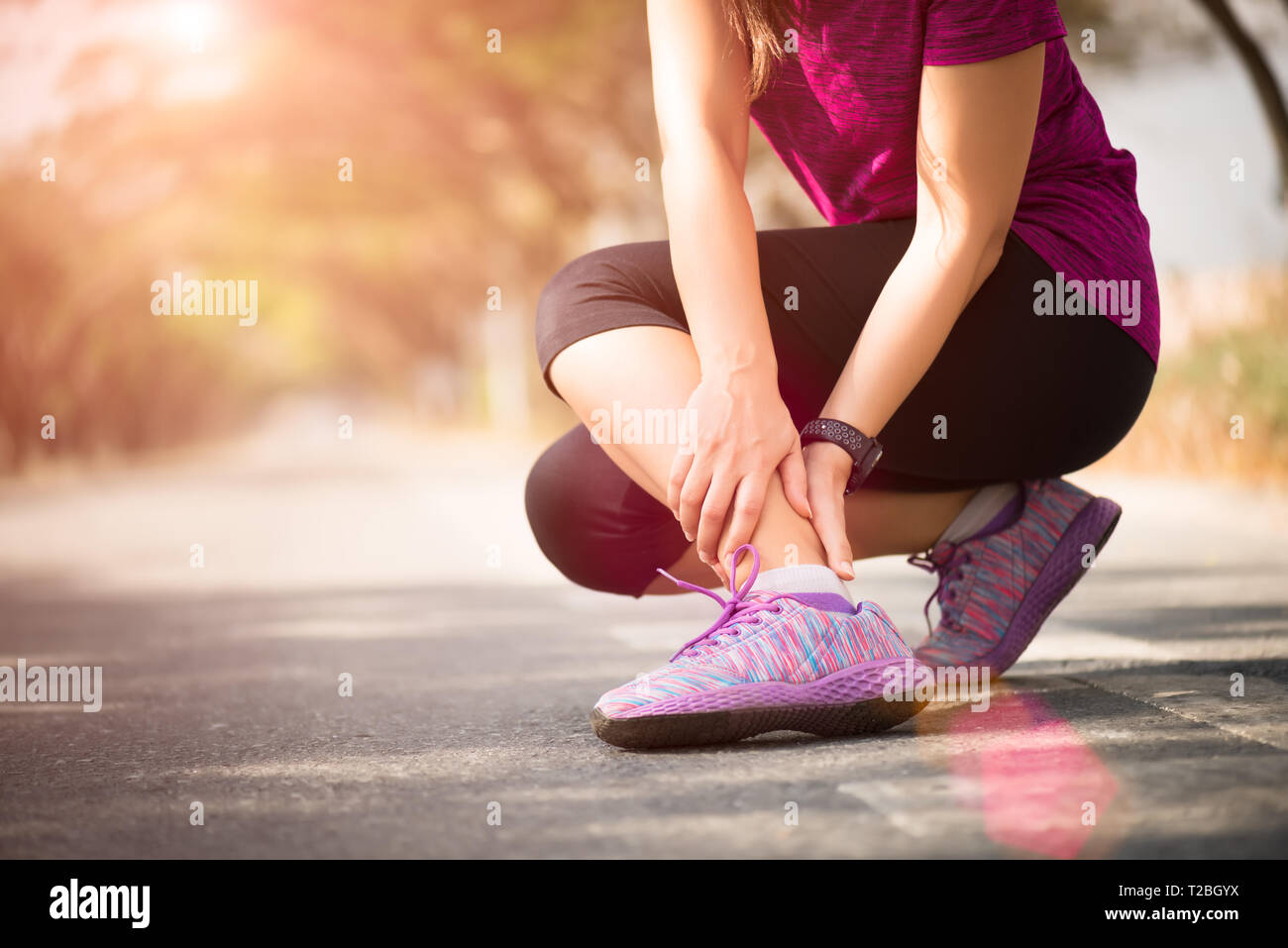Woman suffering from an ankle injury while exercising. Running sport ...