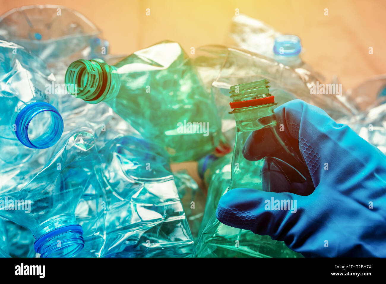 Worker sorting plastic bottles as recycling material Stock Photo - Alamy